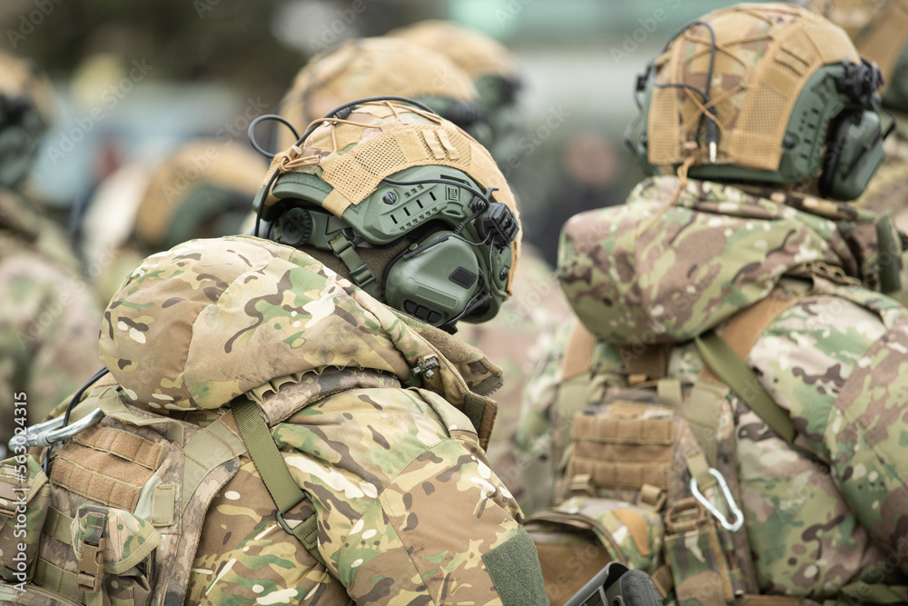 Army soldier with a machine gun in his hand. Soldier, commando standing ...