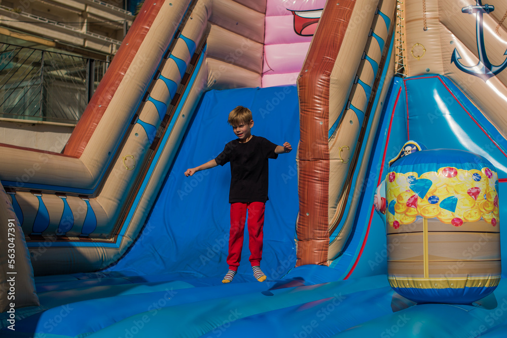 Kids having fun and sliding and jumping on outdoor playground. Kids ...