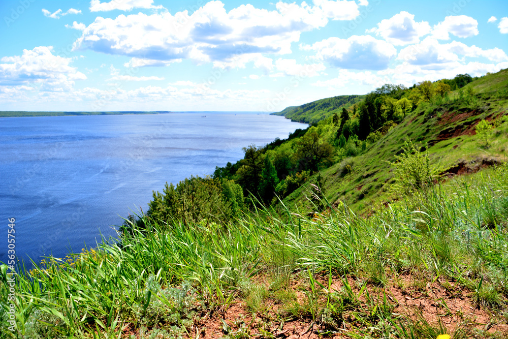 widest place of Volga river with rolling hills with green grass and ...