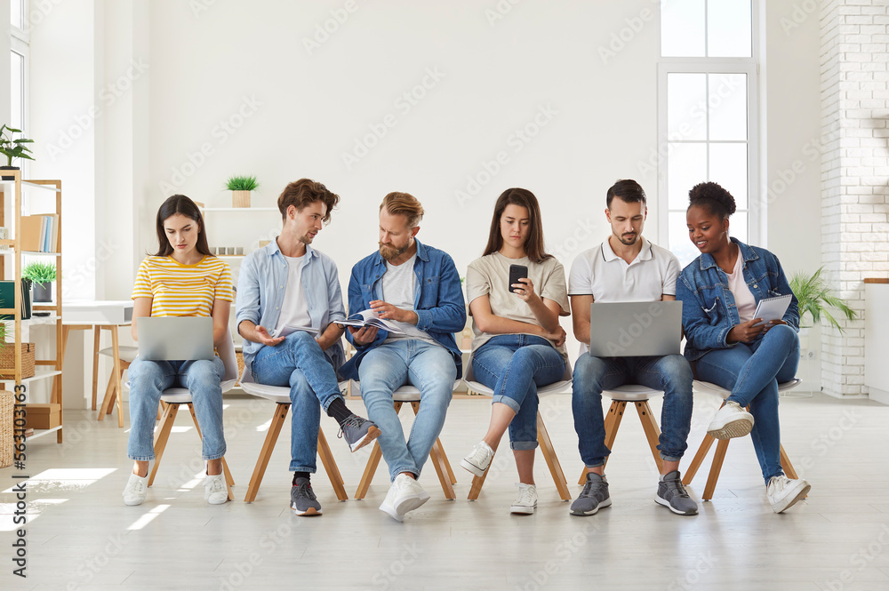 Foto de Group of students using modern digital devices at meeting ...