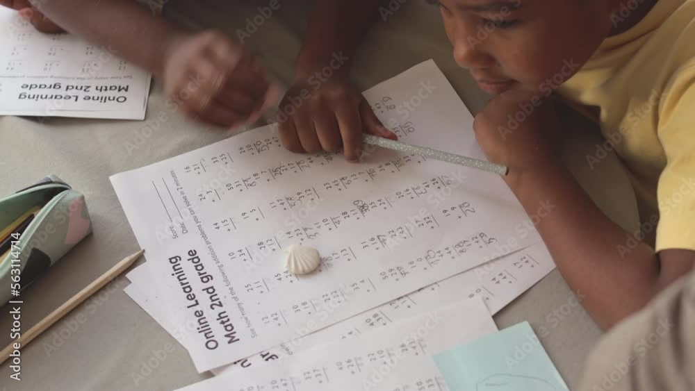 From above shot of elementary school kids doing Math calculations on ...