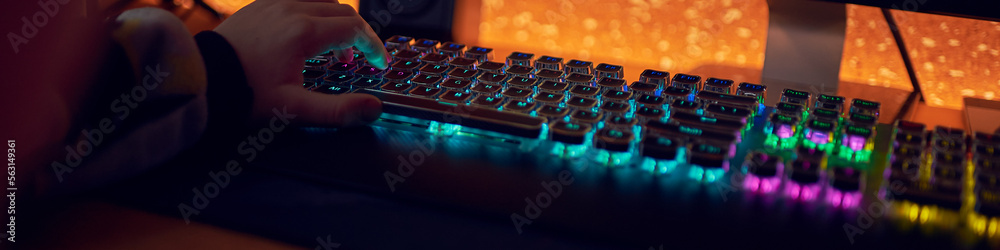 Hands of gamer man playing video games on computer in dark room using ...