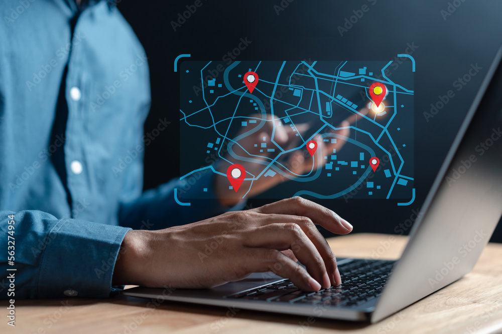 Businessman using smartphone synchronize computer searching world map ...