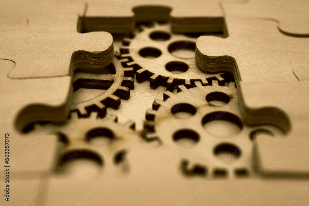 wooden gears under the puzzle, the concept of moving to the next level ...