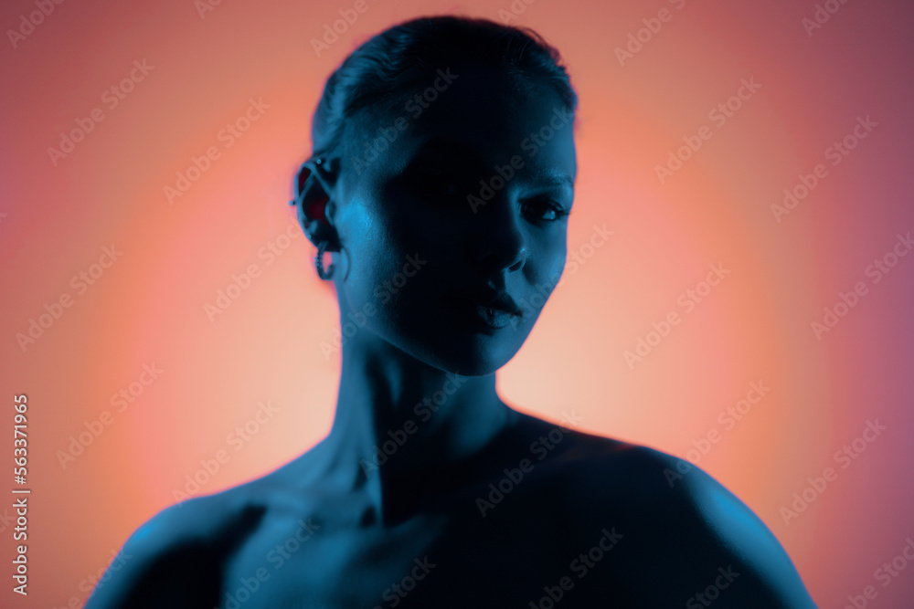 Dark woman profile portrait on pink gradient background with soft blue ...