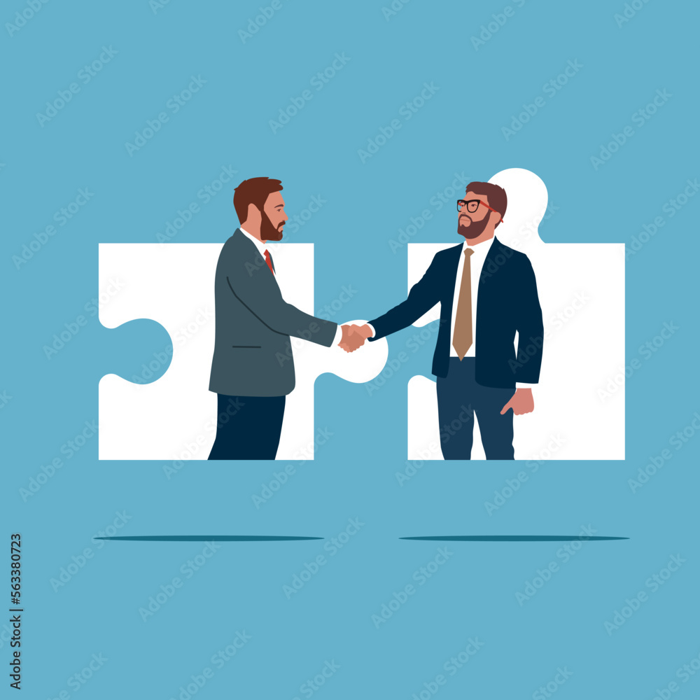Cooperation. Businessmen handshake on jigsaw puzzle. Building ...