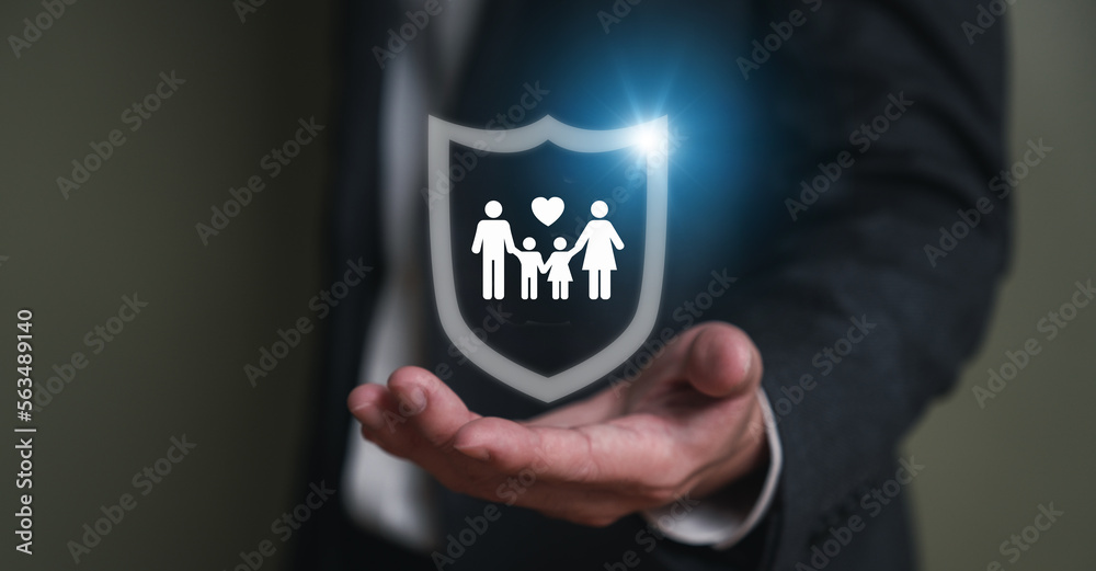 Insurance agent with formal suit using hand to protect customer family ...