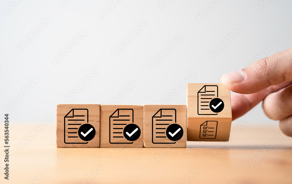 Hand Flipping correct sign with document which print screen on wooden ...