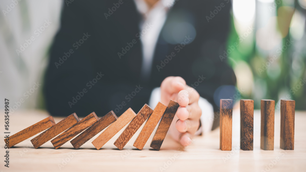 Human hands blocking wooden sticks,Financial risk management and ...