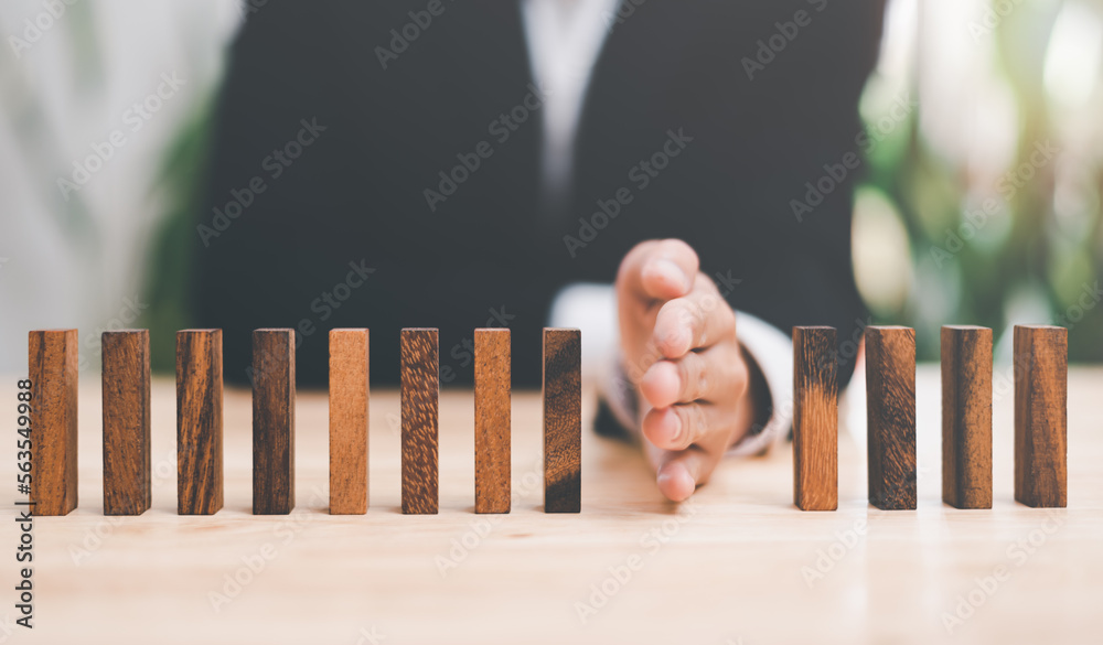 Human hands blocking wooden sticks,Financial risk management and ...
