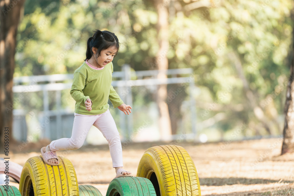 Cute asian girl smile play on school or kindergarten yard or playground ...