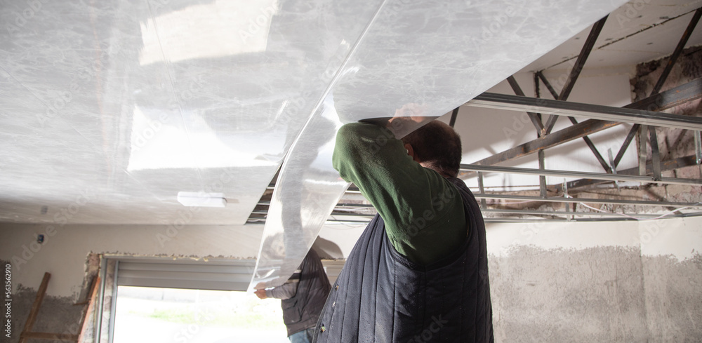 Construction workers assembling a suspended ceiling. Stock Photo ...