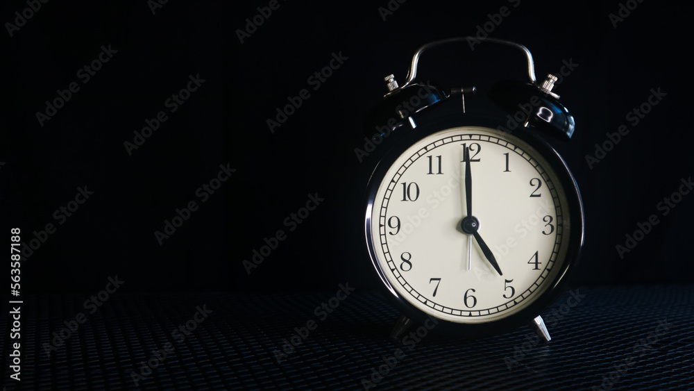 Background photo of an alarm clock showing 5:00 Stock Photo | Adobe Stock