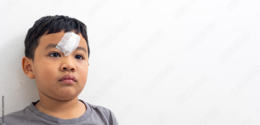 Asian boy is sad He had wound on face and fingers. Asian kid boy was ...