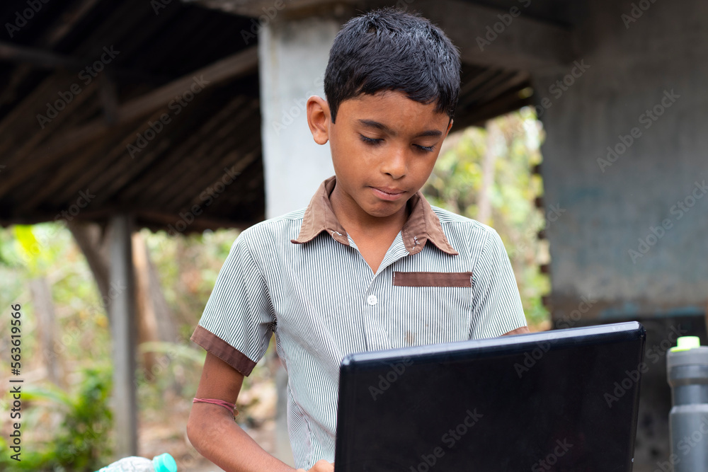 indian village government school boy operating laptop computer system ...