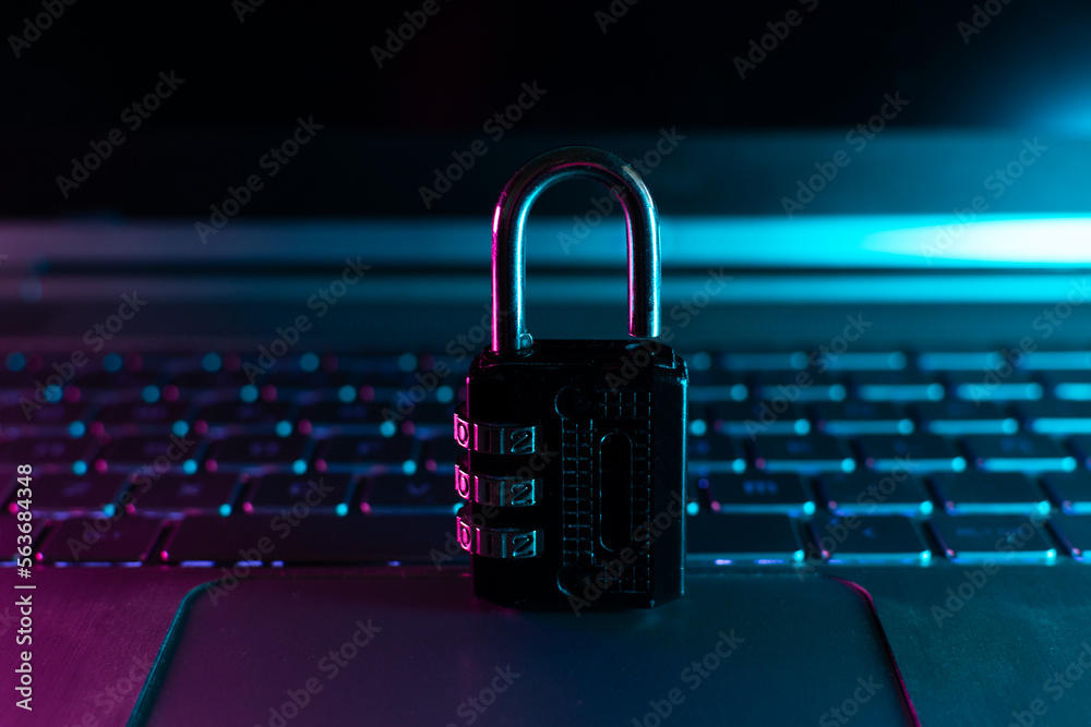 Lock on laptop as computer protection and cyber safety concept on neon ...