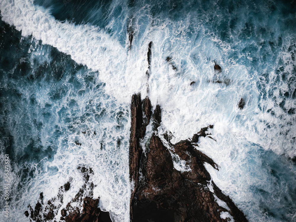 Aerial photo of strong and powerful ocean with huge waves. Rocks and ...