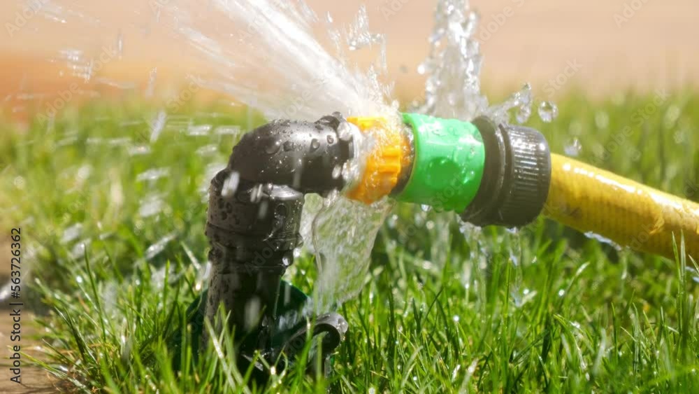 Slow motion of water droplet leaking through damaged garden hose and ...