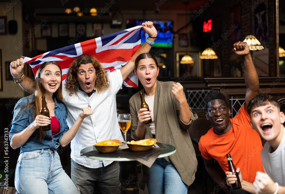 International group of people with UK flag toasting with beer, having ...