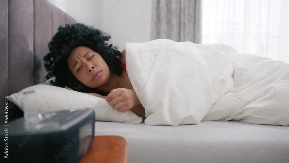 Sleepy black girl covers up in blanket and continue to sleep slow ...