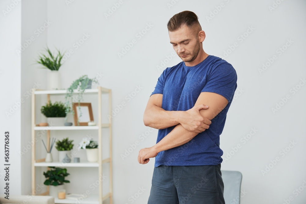 Photo & Art Print A man has pain in his arm, sprain of muscles and ...