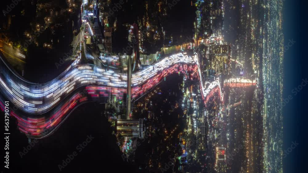 Vertical mobile oriented time lapse bright night motion of speedy night ...