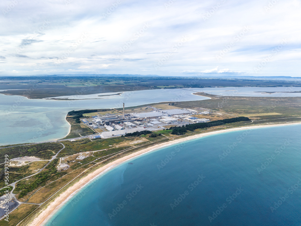 High angle aerial drone view of Tiwai Point peninsula at the entrance ...
