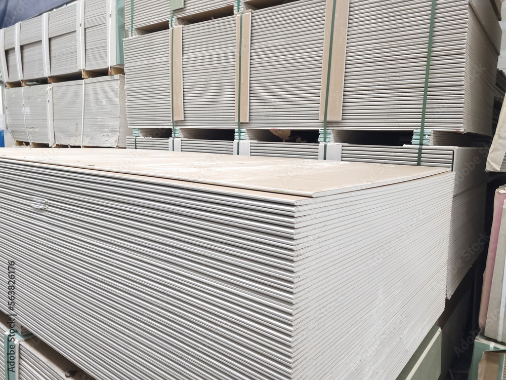 plasterboard sheets stacked in a hardware store. dry gypsum plaster ...