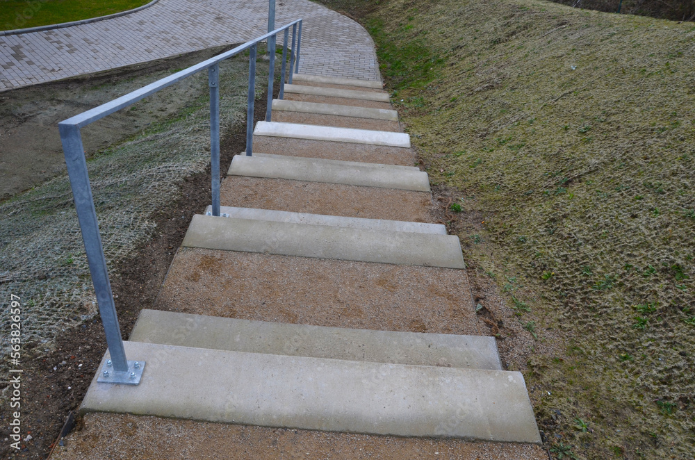 outdoor park stairs on a slope. jute mat protects against erosion. seed ...