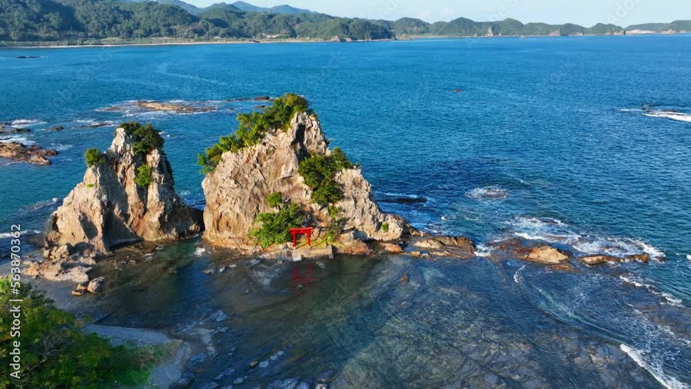 picturesque seascape with a tiny rocky island with Asian shrine in ...