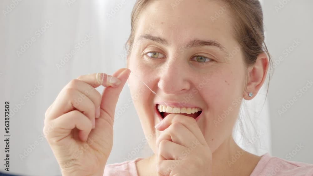 Video Stock Closeup of young brunette woman taking care of her teeth ...