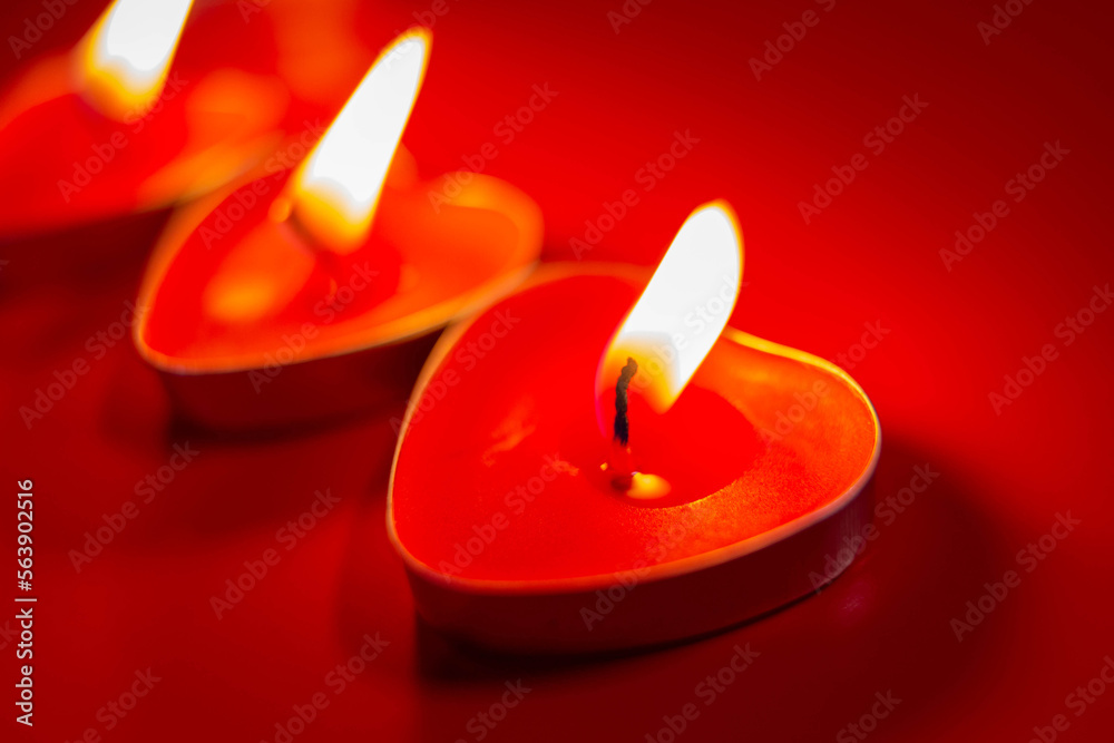 Red burning candles in the shape of a heart with a blazing flame ...