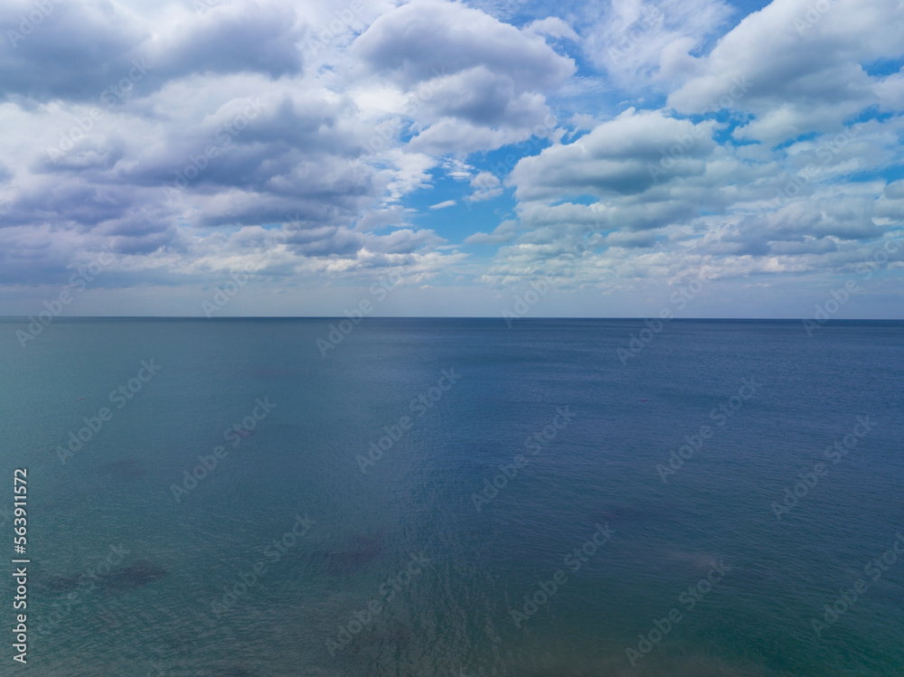 Aerial view of a blue sea surface water texture background and sun ...
