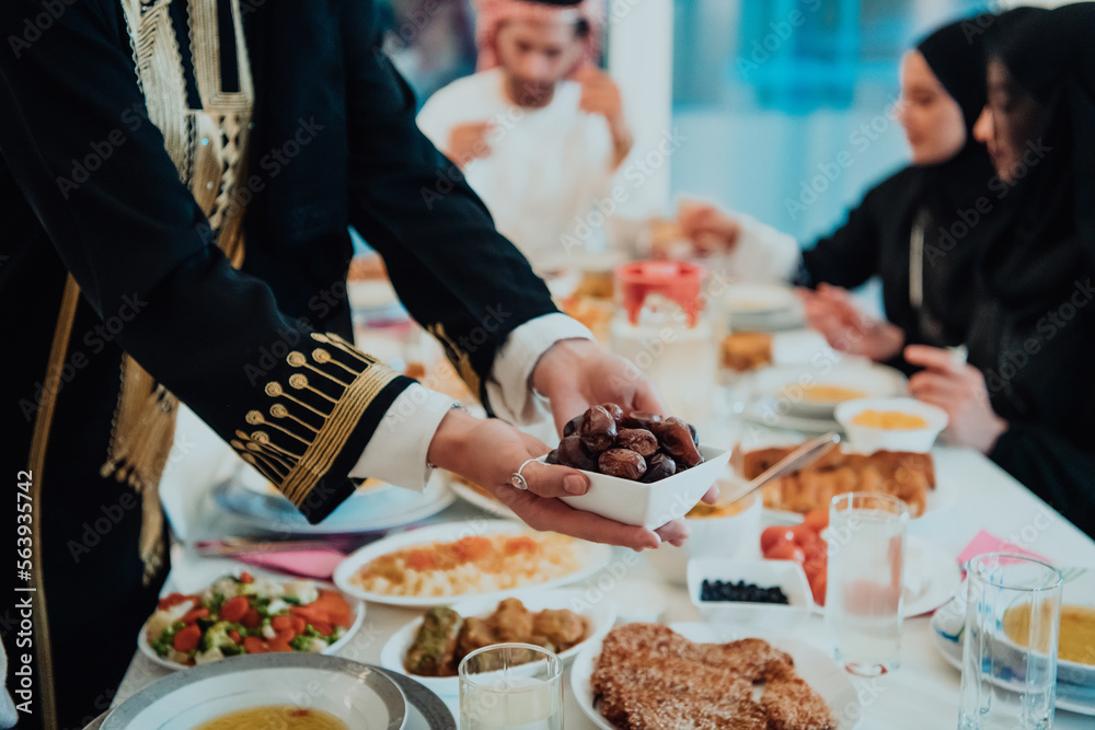 Muslim family having Iftar dinner drinking water to break feast. Eating ...
