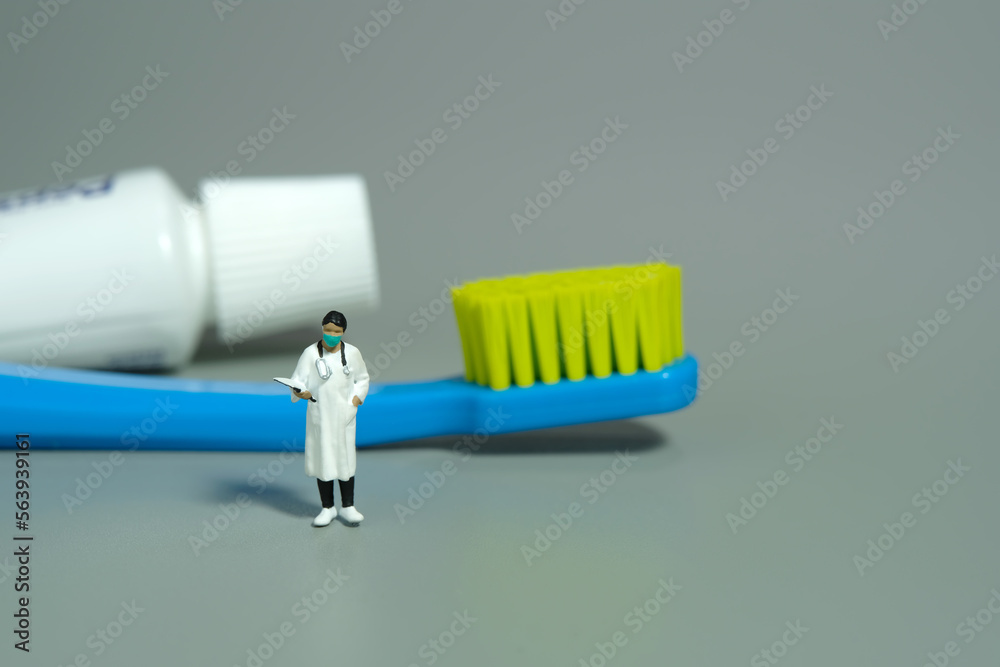 Miniature people toy figure photography. Mouth and teeth health. A ...