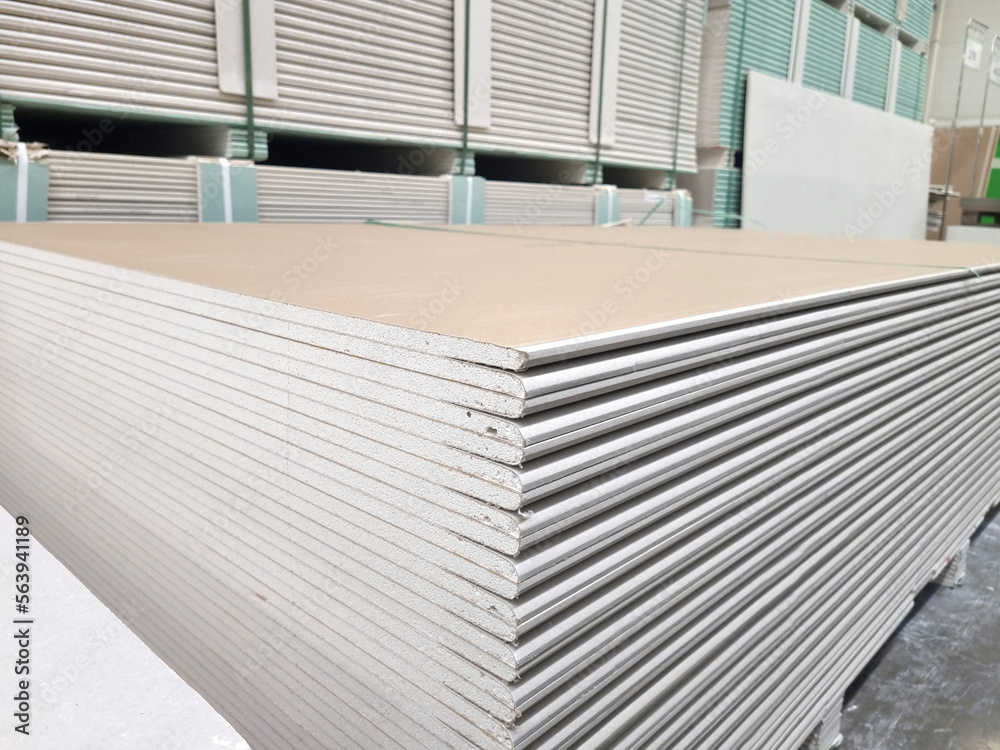 plasterboard sheets stacked in a hardware store. dry gypsum plaster ...