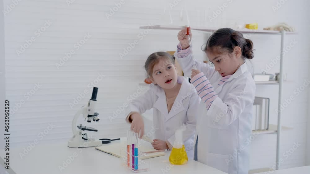4K, Two schoolgirls, classroom, doing chemistry science experiments ...