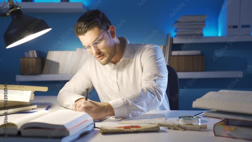 Historian young man examining and translating historical manuscript ...