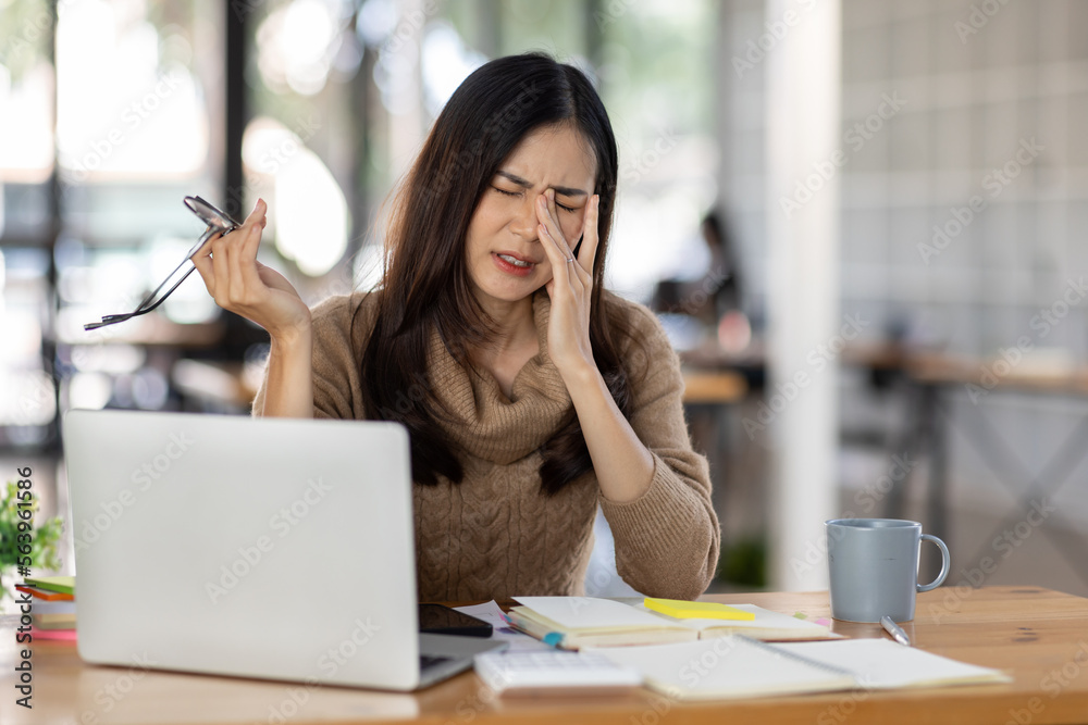 Tired Young freelance asian business woman with headache at office ...