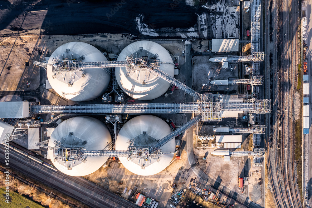 Aerial view directly above large biomass storage tanks at a Power ...