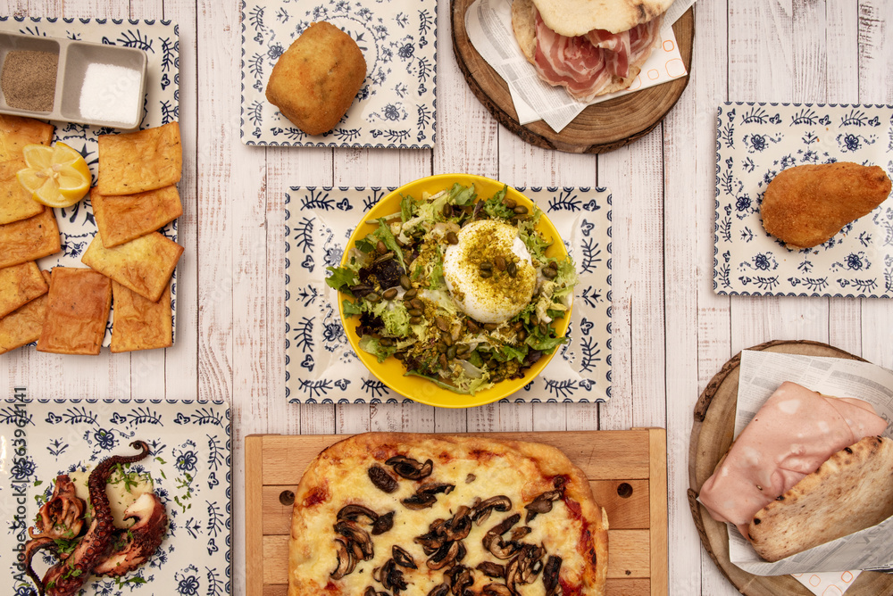 Set of dishes of typical Italian cuisine with a burrata salad with nuts ...