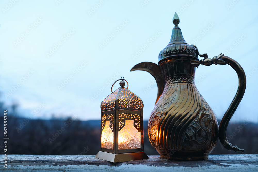 Glowing Moroccan lantern, golden ornamental arabic coffee pot dallah ...