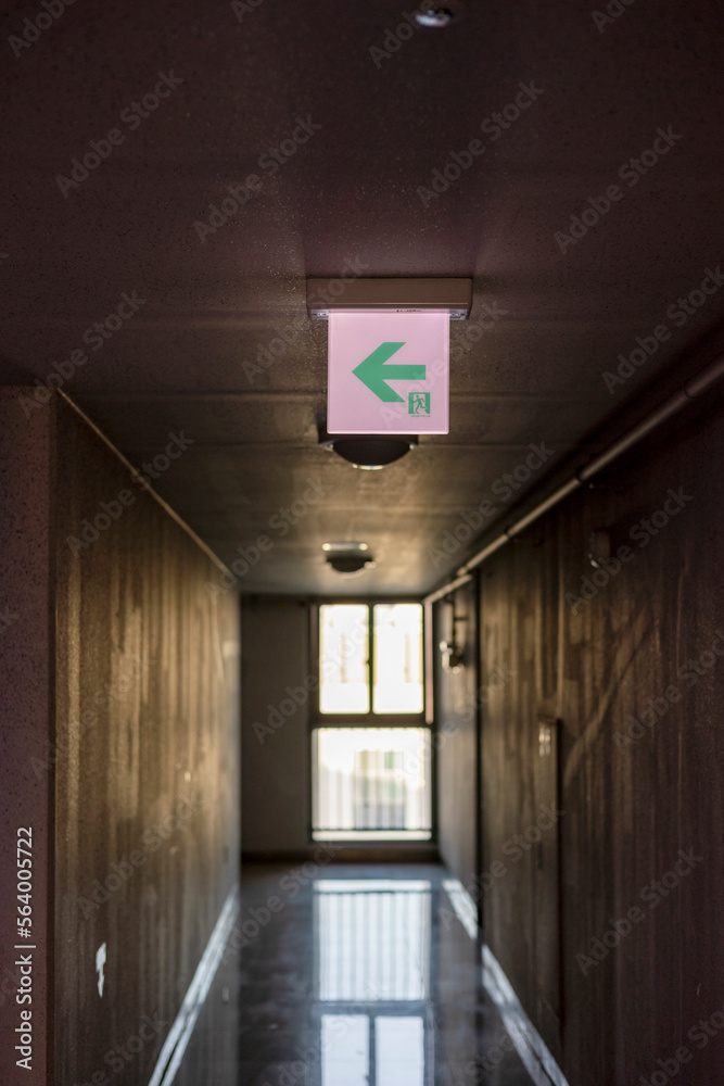 Emergency exit sign at the hallway of building Stock Photo | Adobe Stock