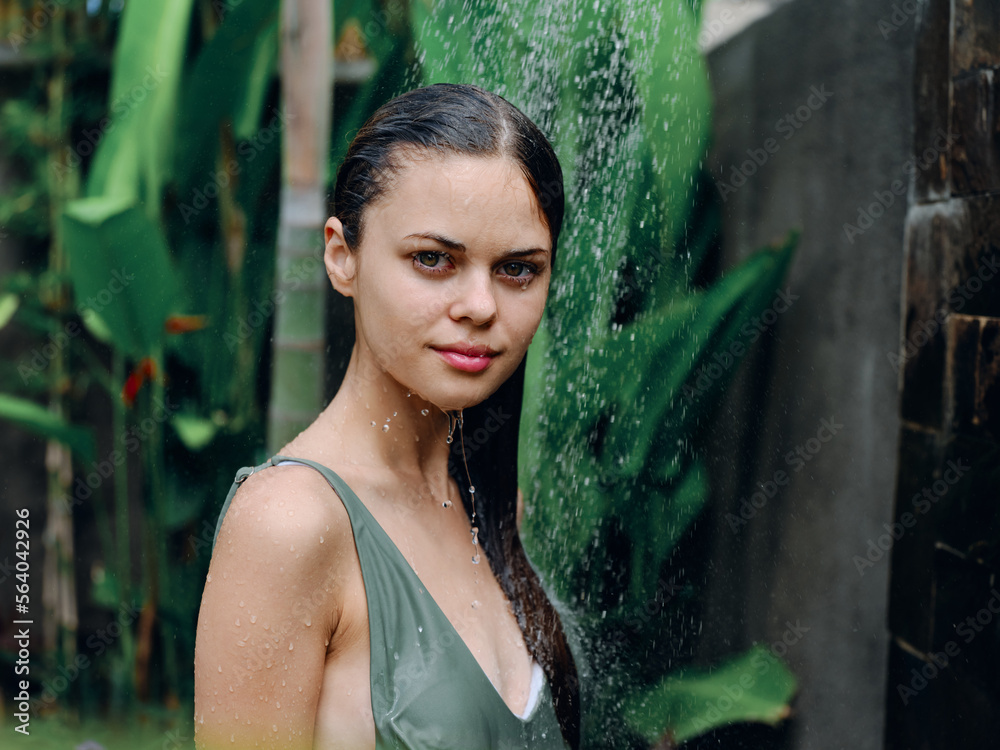A Woman A Body In A Swimsuit Washes Her Head In A Tropical Shower