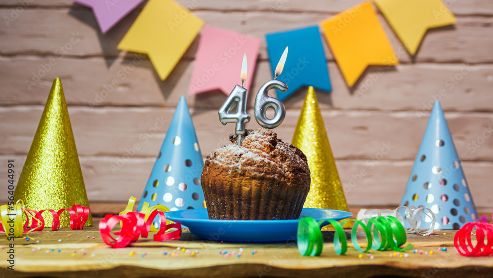 Festive cake with a candle with a number 46. Happy birthday background ...