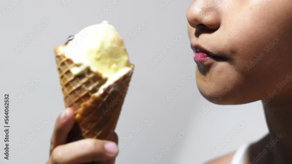 detailed view of a little girl's mouth, licking the ice cream cone ...