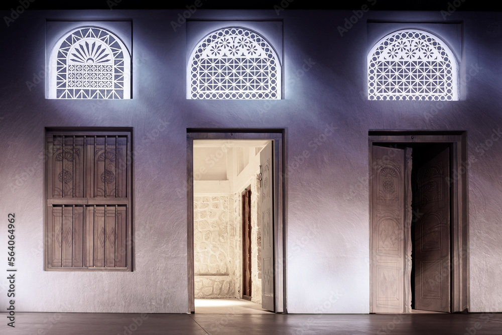 Arabic style window portals and carved wooden doors with arabesque ...
