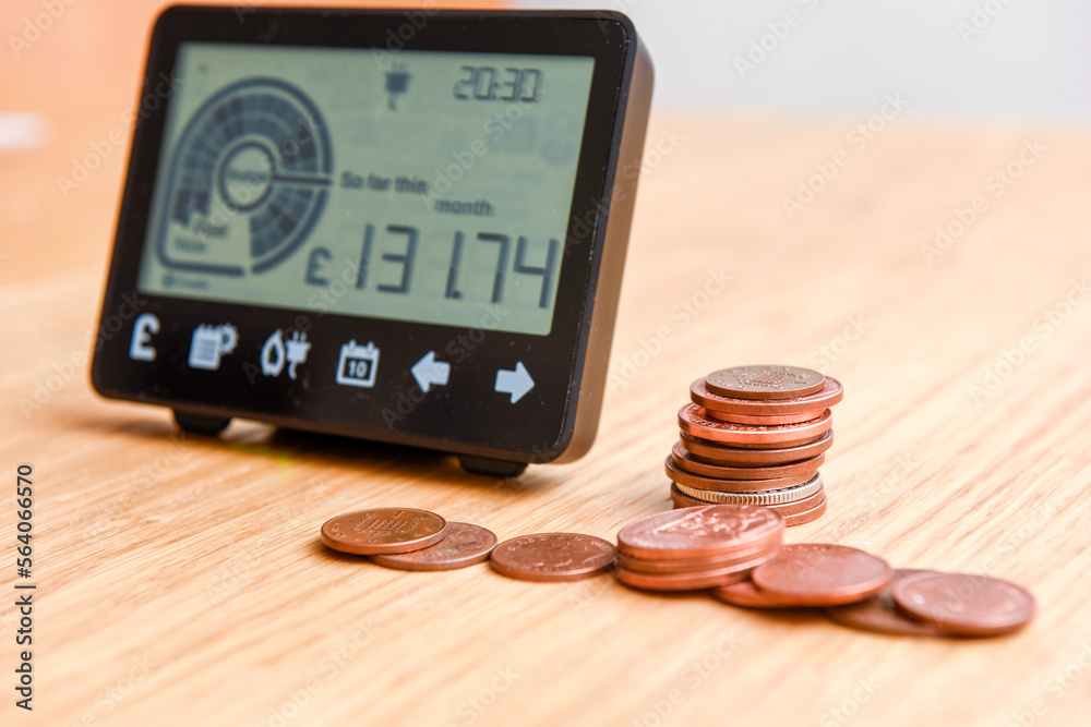Smart meter and coins to represent cost of fuel and electricity for ...