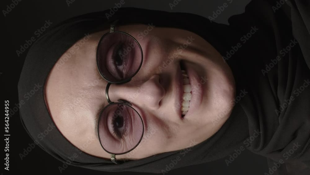 Vertical video of close-up portrait of a Muslim woman with beautiful ...
