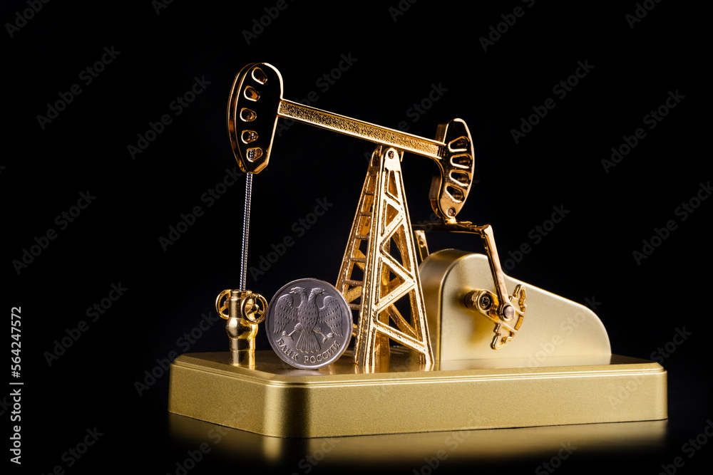 A gold oil pump and the reverse side of a 20-ruble coin depicting a ...